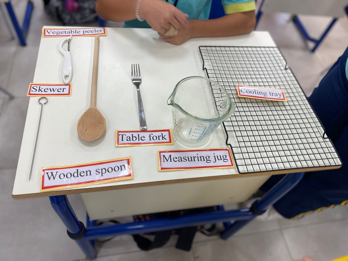 Learning about the different kitchen utensils - St Thomas More College